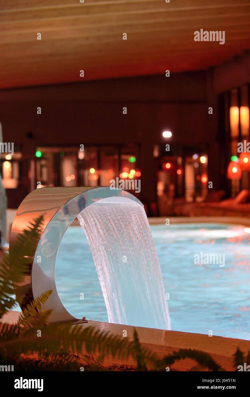 Relaxation pool in spa with waterfall Stock Photo - Alamy