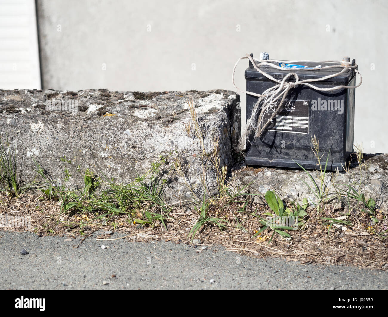 Toxic waste. Old lead battery dumped by roadside. Unbranded Stock Photo ...