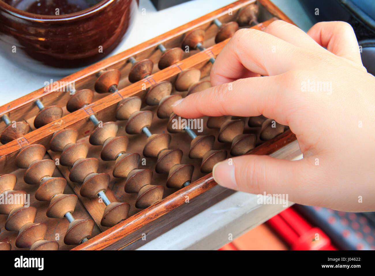 Woman's hand accounting with old abacus Stock Photo - Alamy