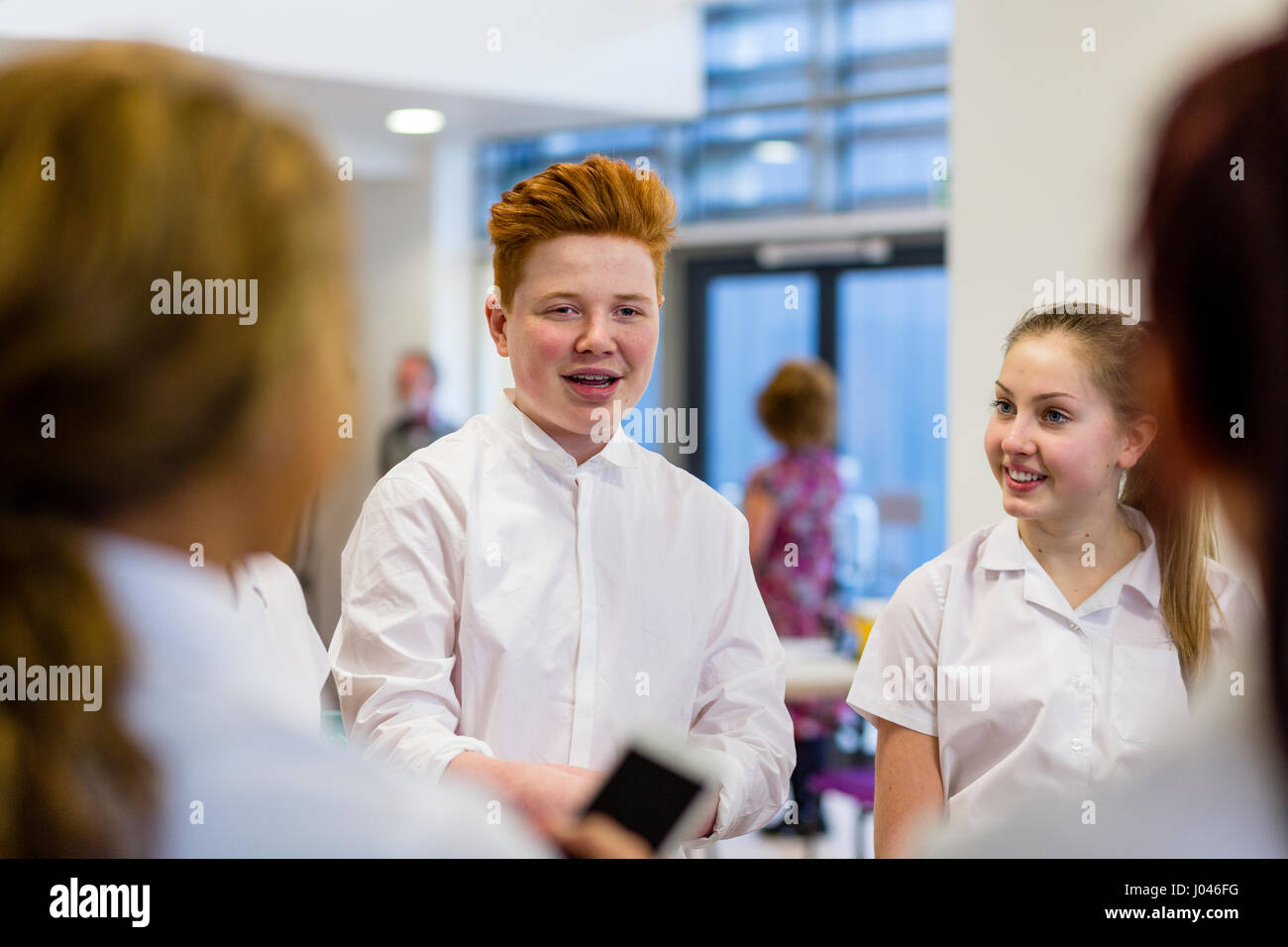 Three school students talking hi-res stock photography and images - Alamy