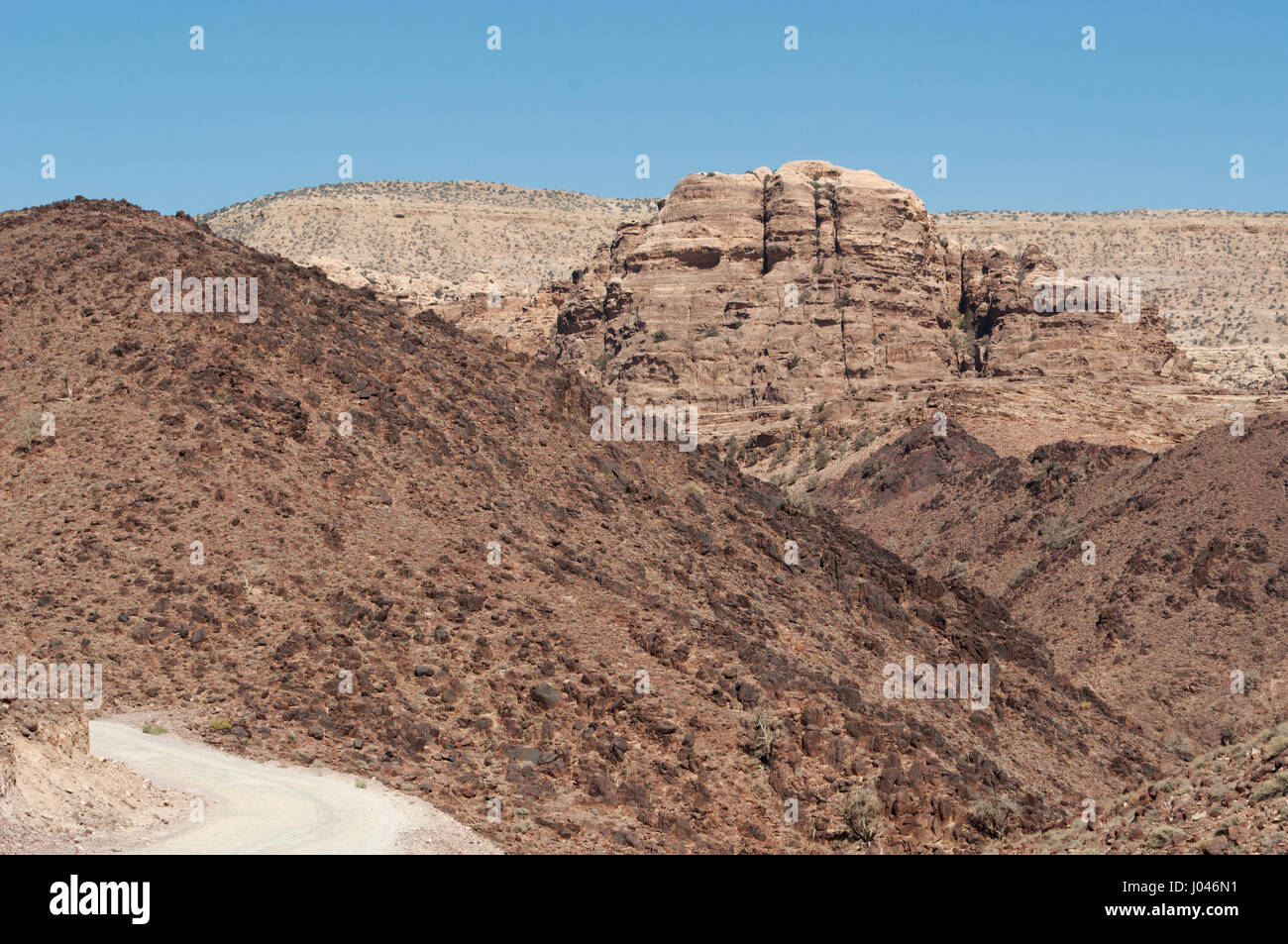 The mountain and desertic landscape seen from the road that links the ...