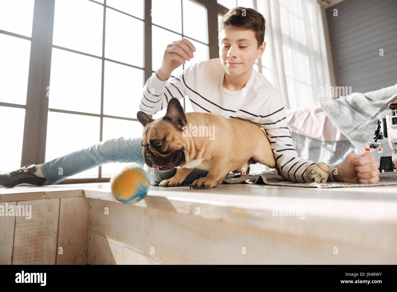 Funny teenager throwing small ball Stock Photo - Alamy