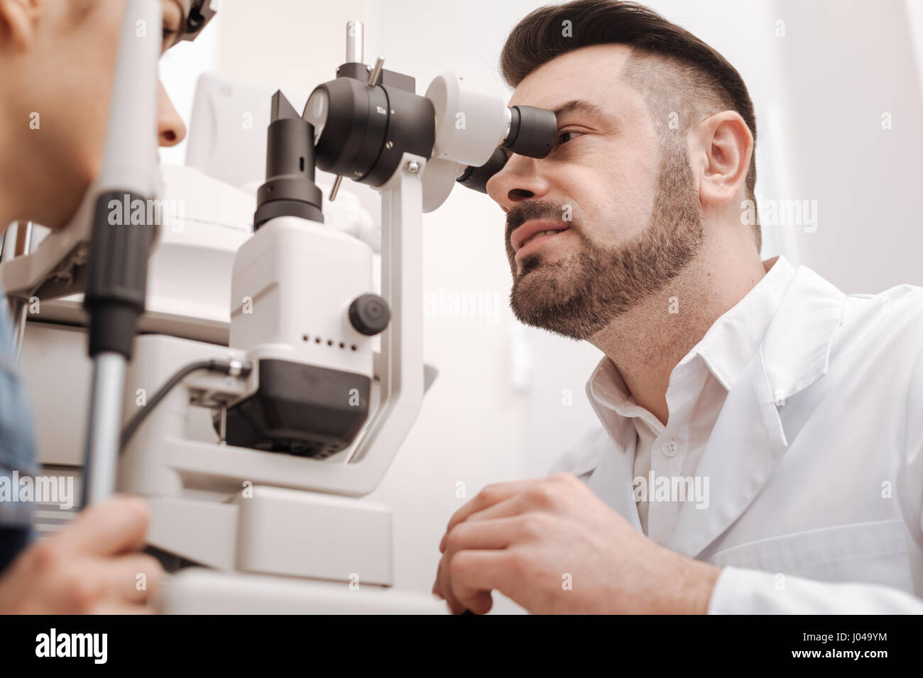 Medical examination. Nice handsome intelligent doctor sitting opposite ...