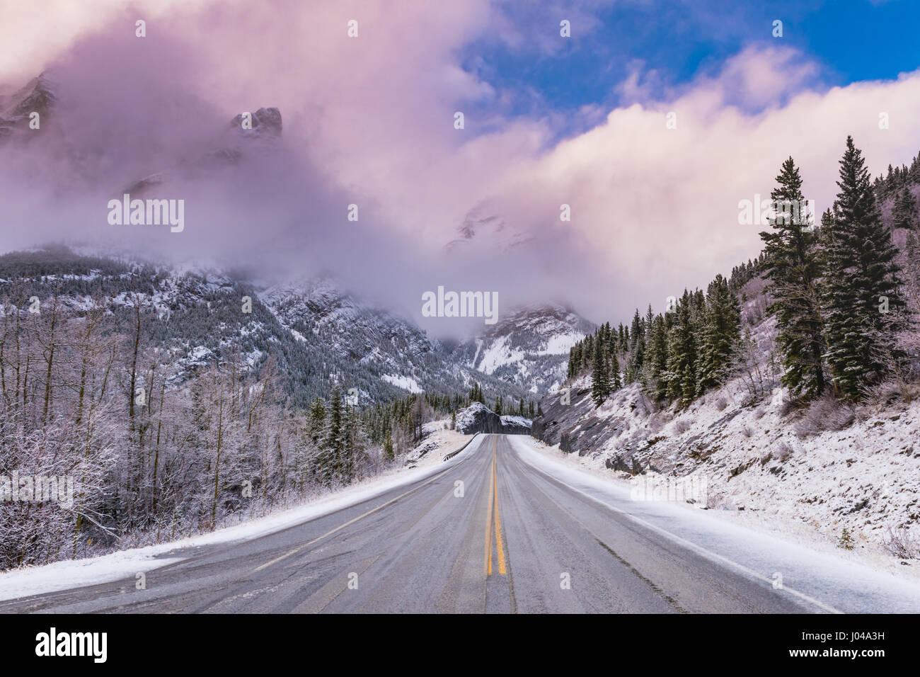 Winter highway driving through a storm on a mountain pass, Alberta ...