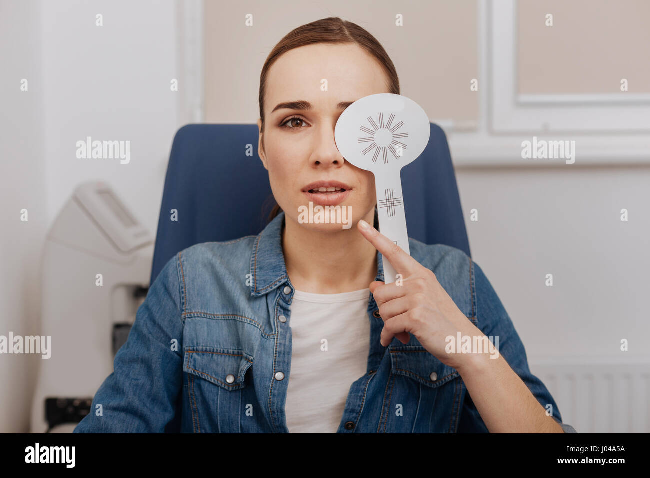 Nice pleasant woman closing her left eye Stock Photo - Alamy