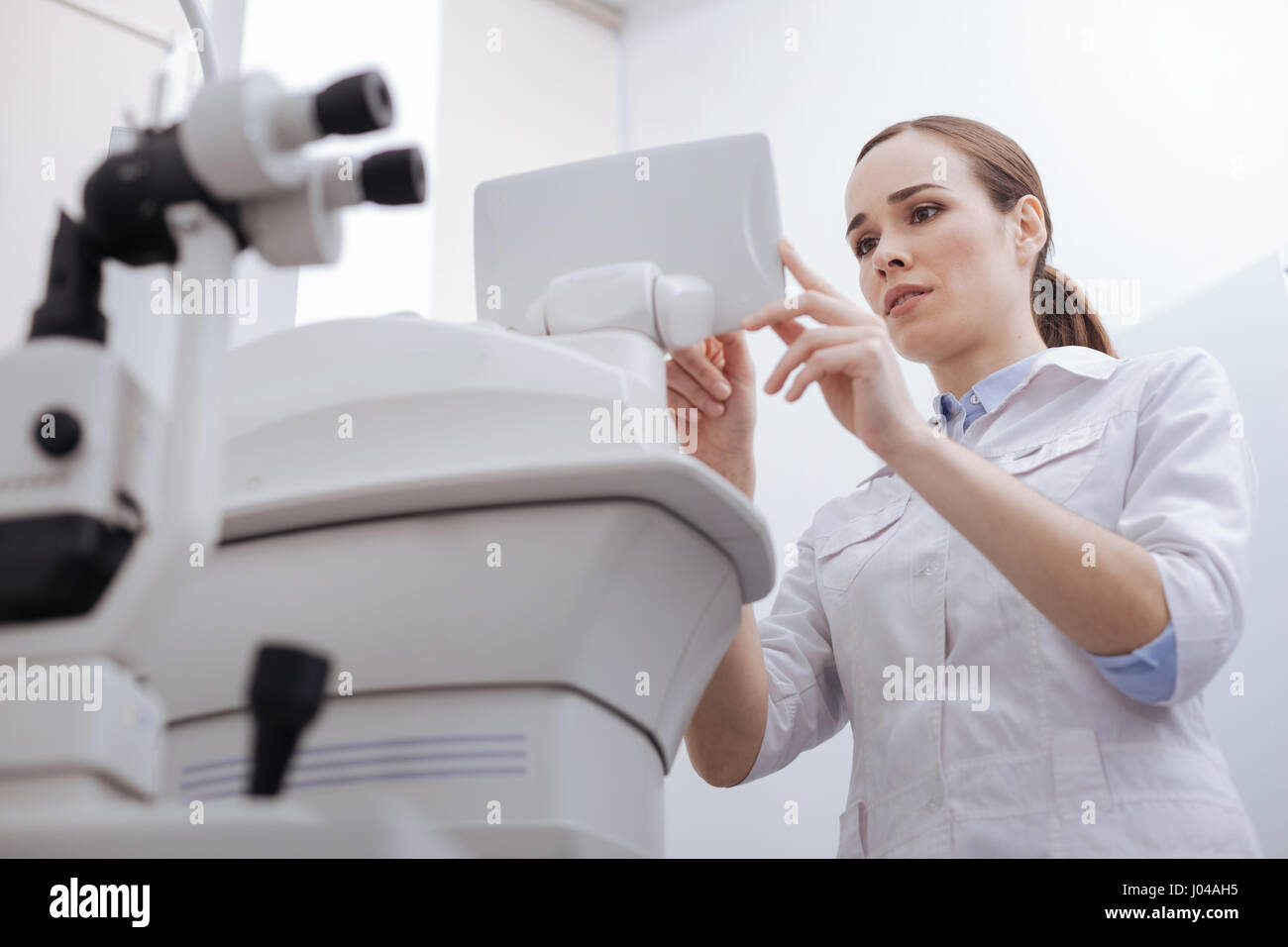 Good looking pleasant woman looking at the control panel Stock Photo ...