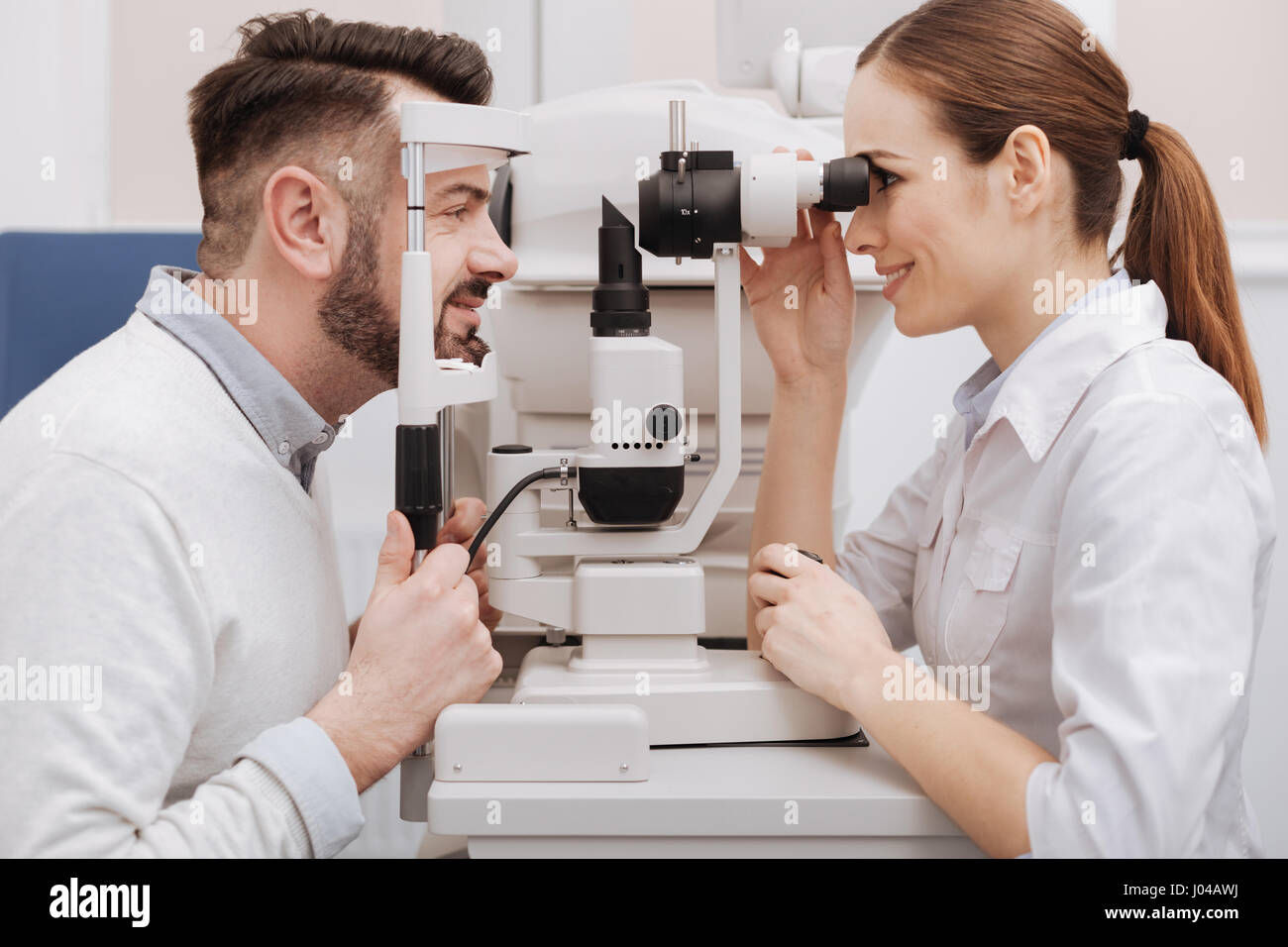 Cheerful delighted man having his eyes tested Stock Photo - Alamy