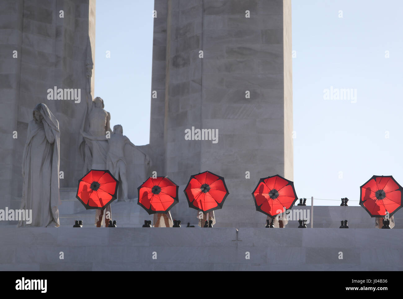 People holding poppy umbrellas at Vimy Memorial Park in France, during ...