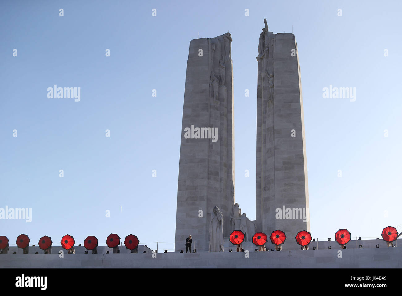 People holding poppy umbrellas at Vimy Memorial Park in France, during ...