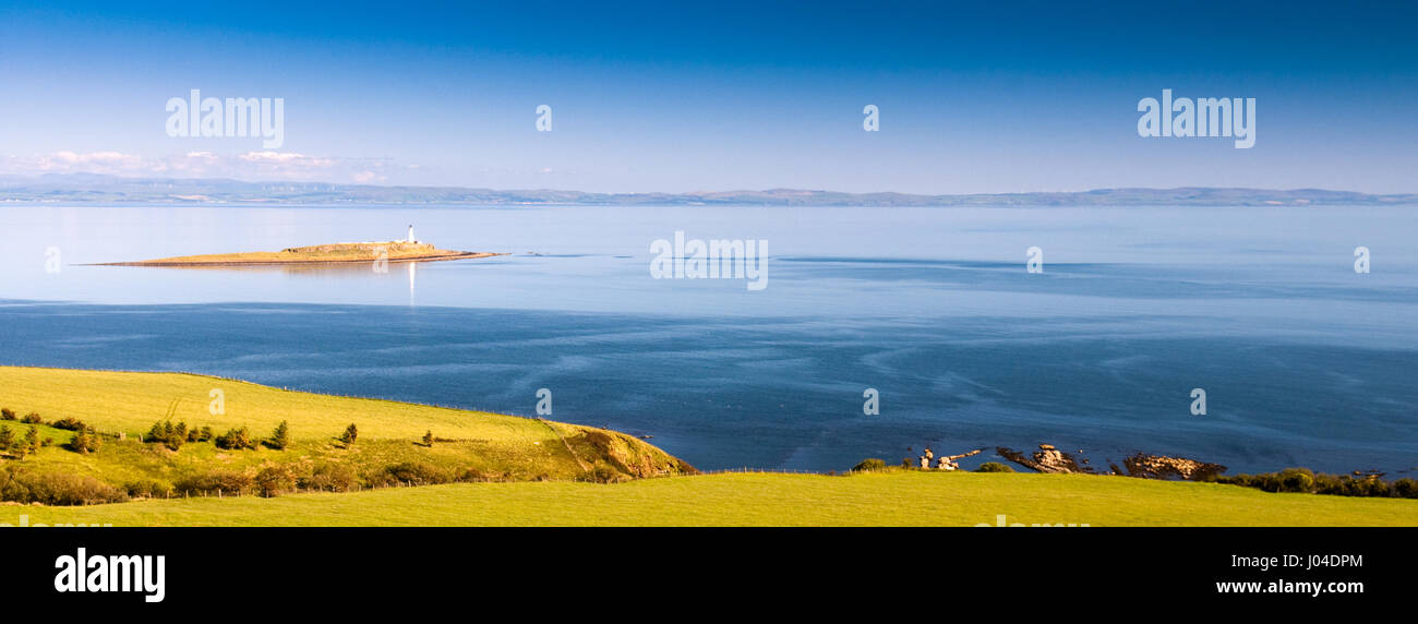 The lighthouse and small island of Pladda in the brilliant blue sea of ...