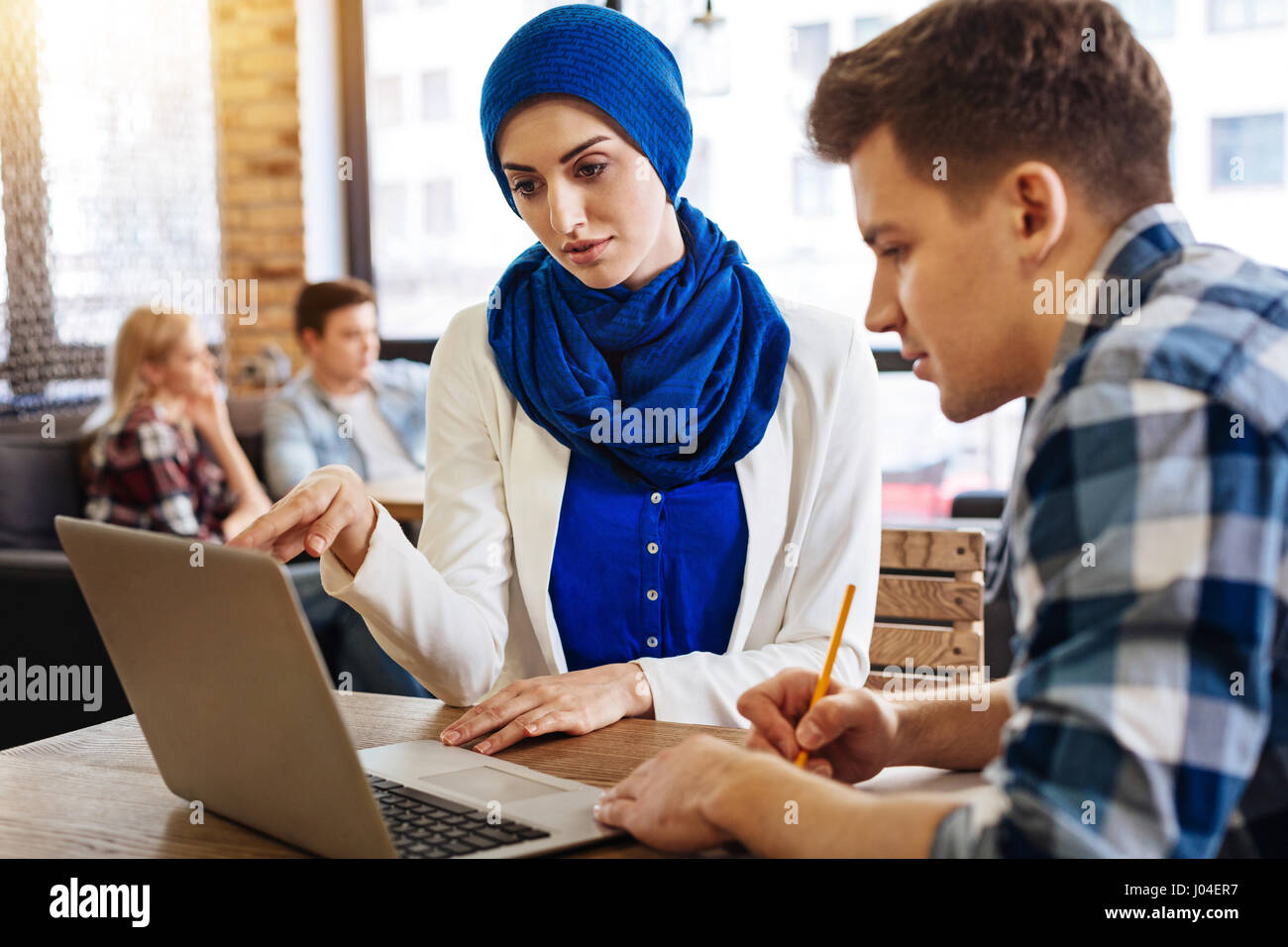 Nice muslim woman studying with her groupmates Stock Photo - Alamy