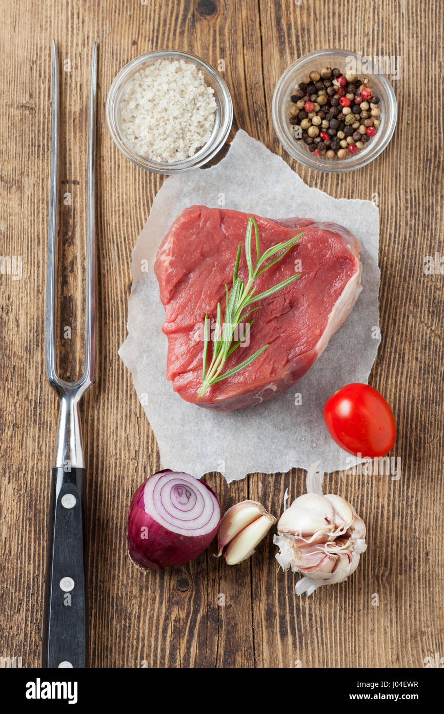 overview of a raw steak on wood Stock Photo - Alamy
