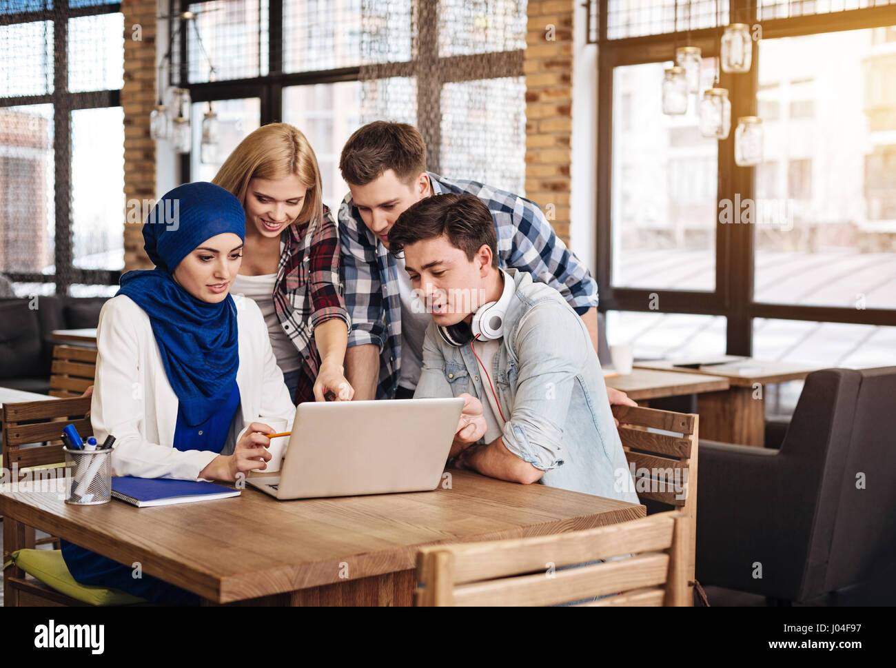 Positive international students working together Stock Photo - Alamy