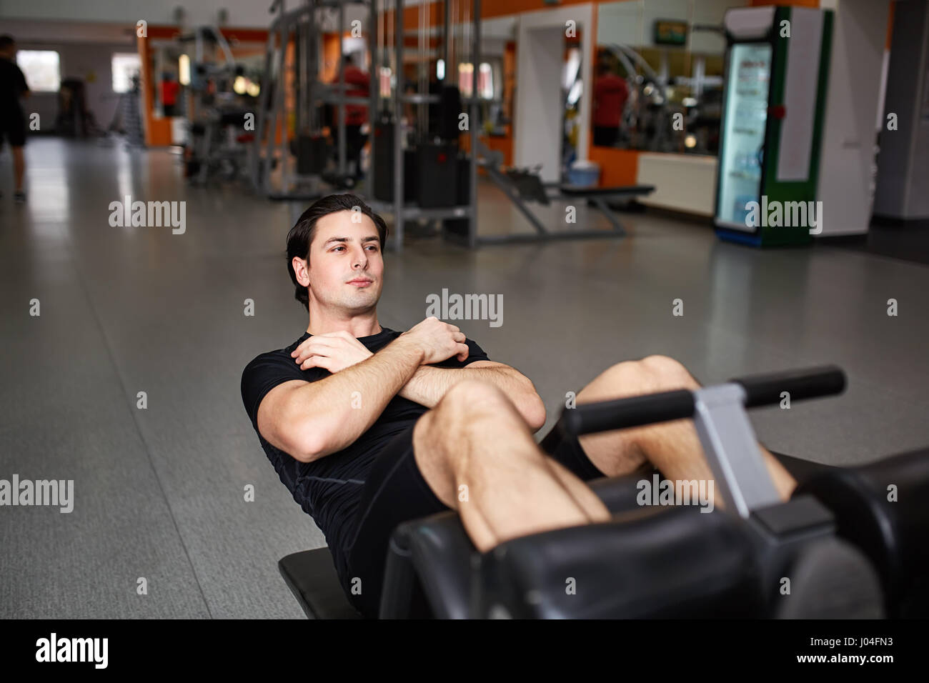 Full length portrait of muscular build man while doing push up exercise ...