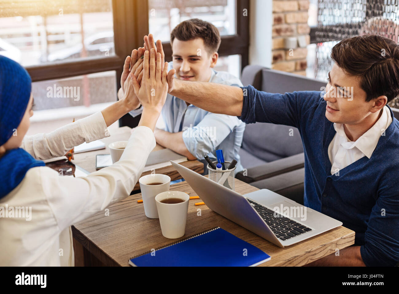 Positive colleagues working together Stock Photo - Alamy