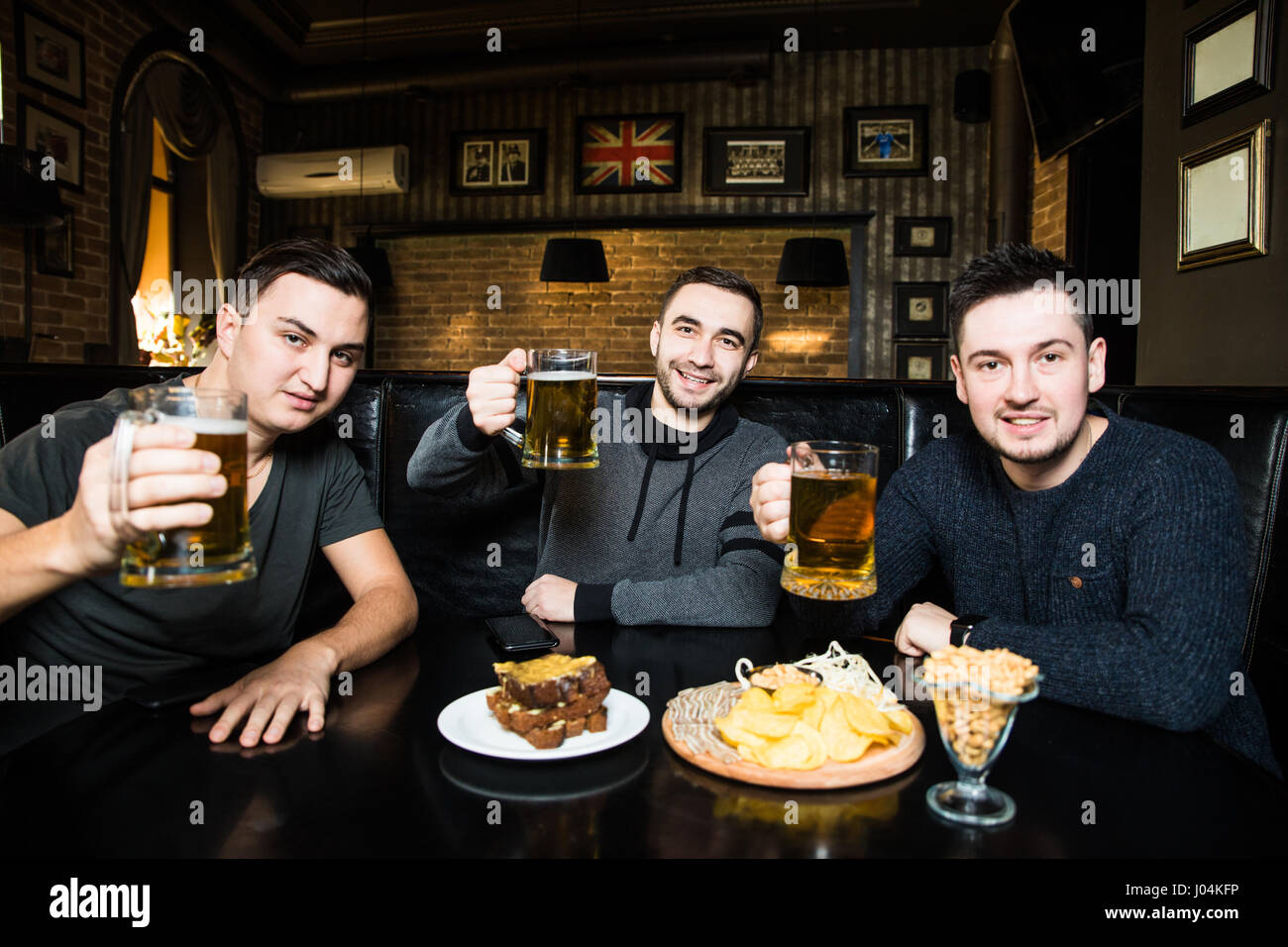 Young business men in a bar with beer Stock Photo - Alamy