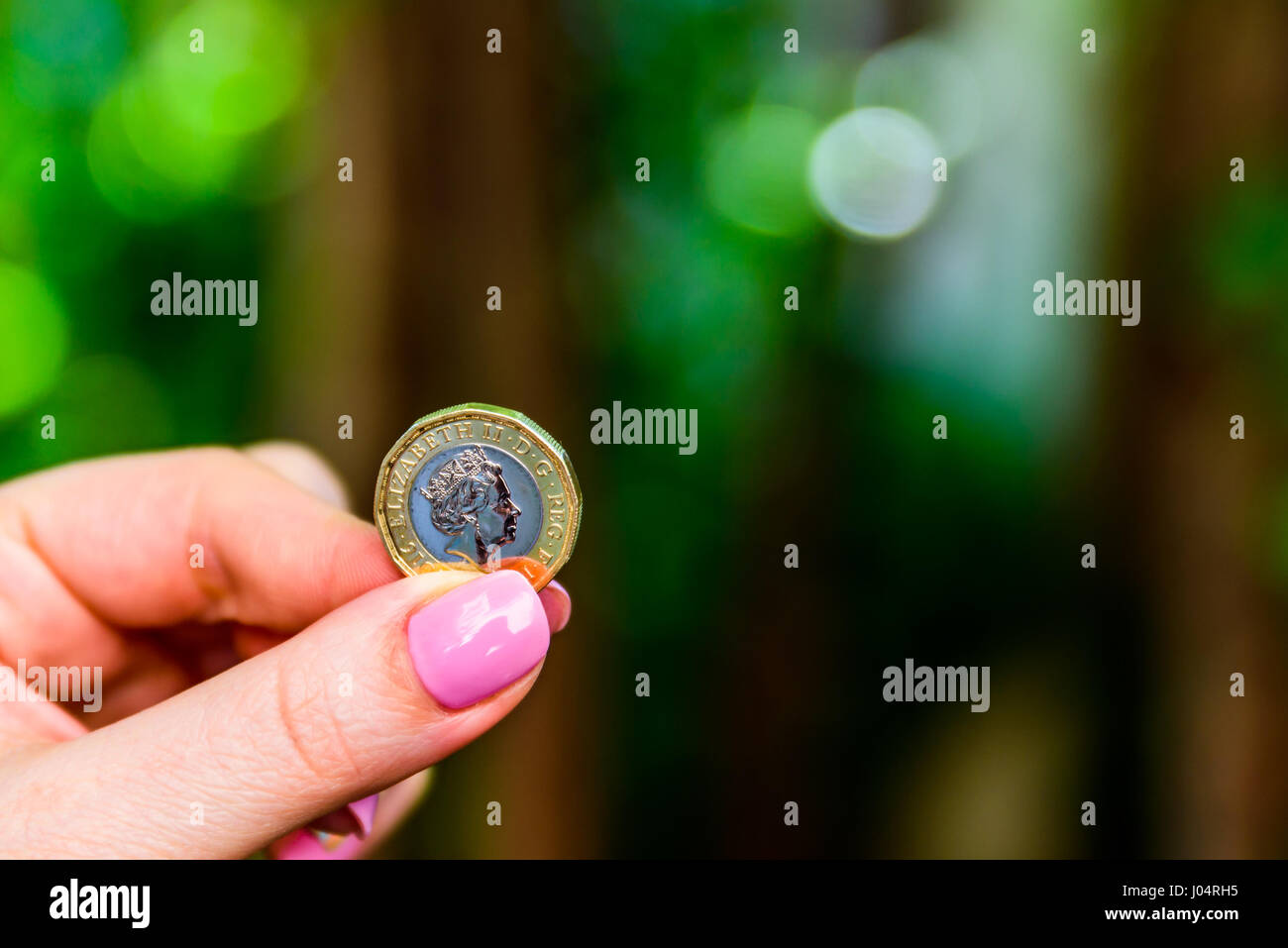 Female hand holding stack gold hi-res stock photography and images - Alamy