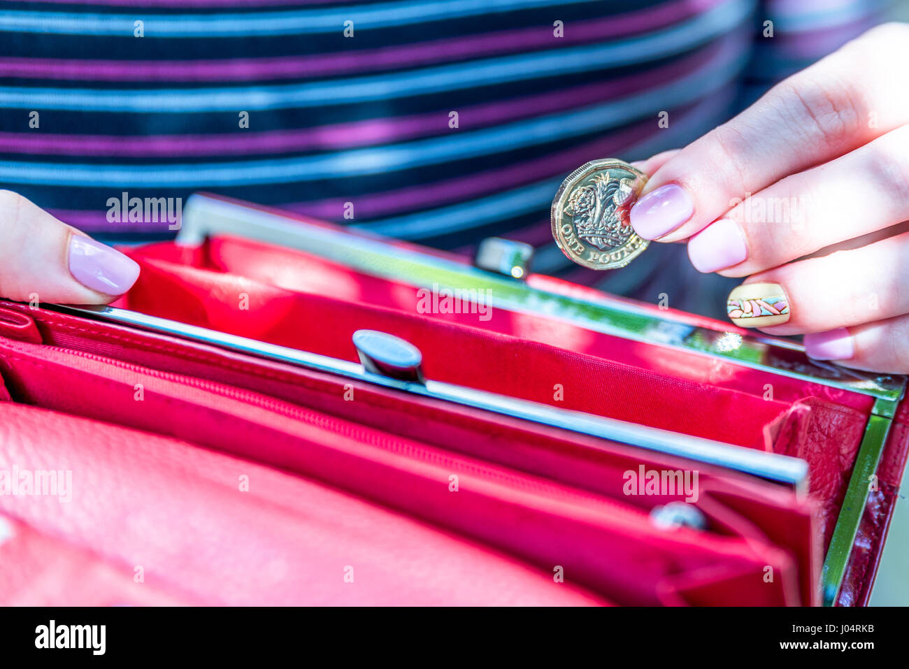 Female hand holding new british one sterling pound coin wallet Stock ...