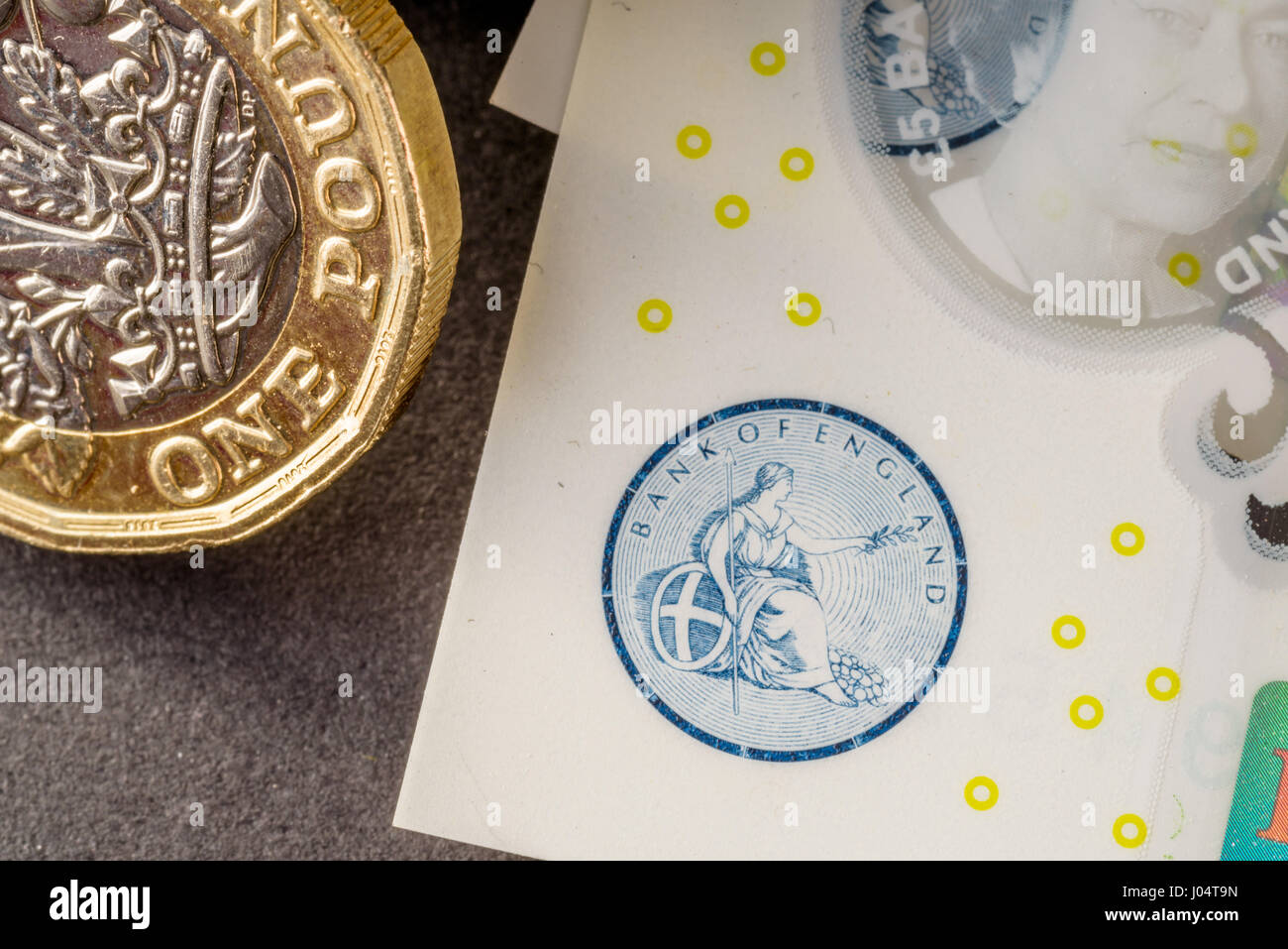 New five sterling pounds note and one pound coin Stock Photo - Alamy