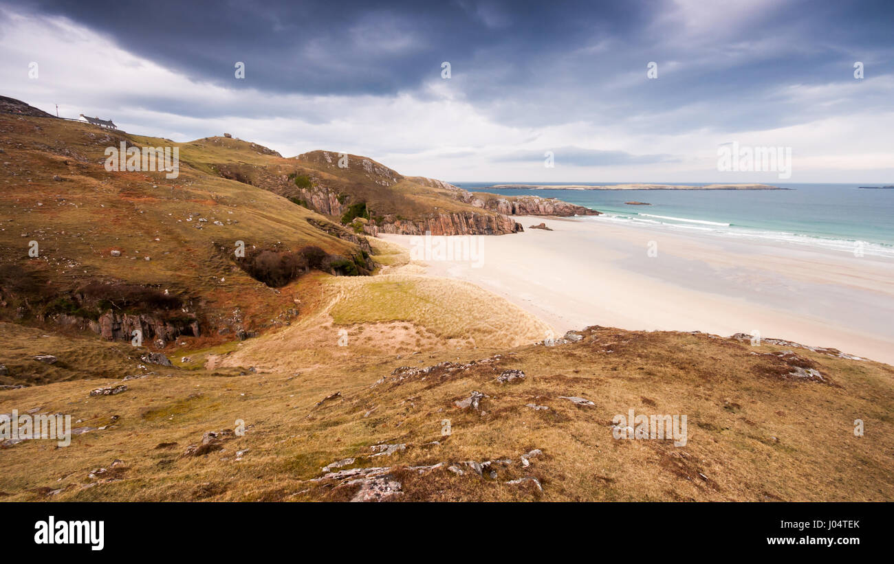 Sandy beaches and low grassy cliffs at Ceannabeinne, Sutherland, in the ...