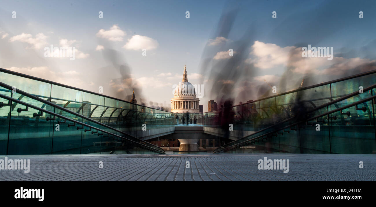 Pedestrians cross the River Thames on the Millennium Bridge between ...