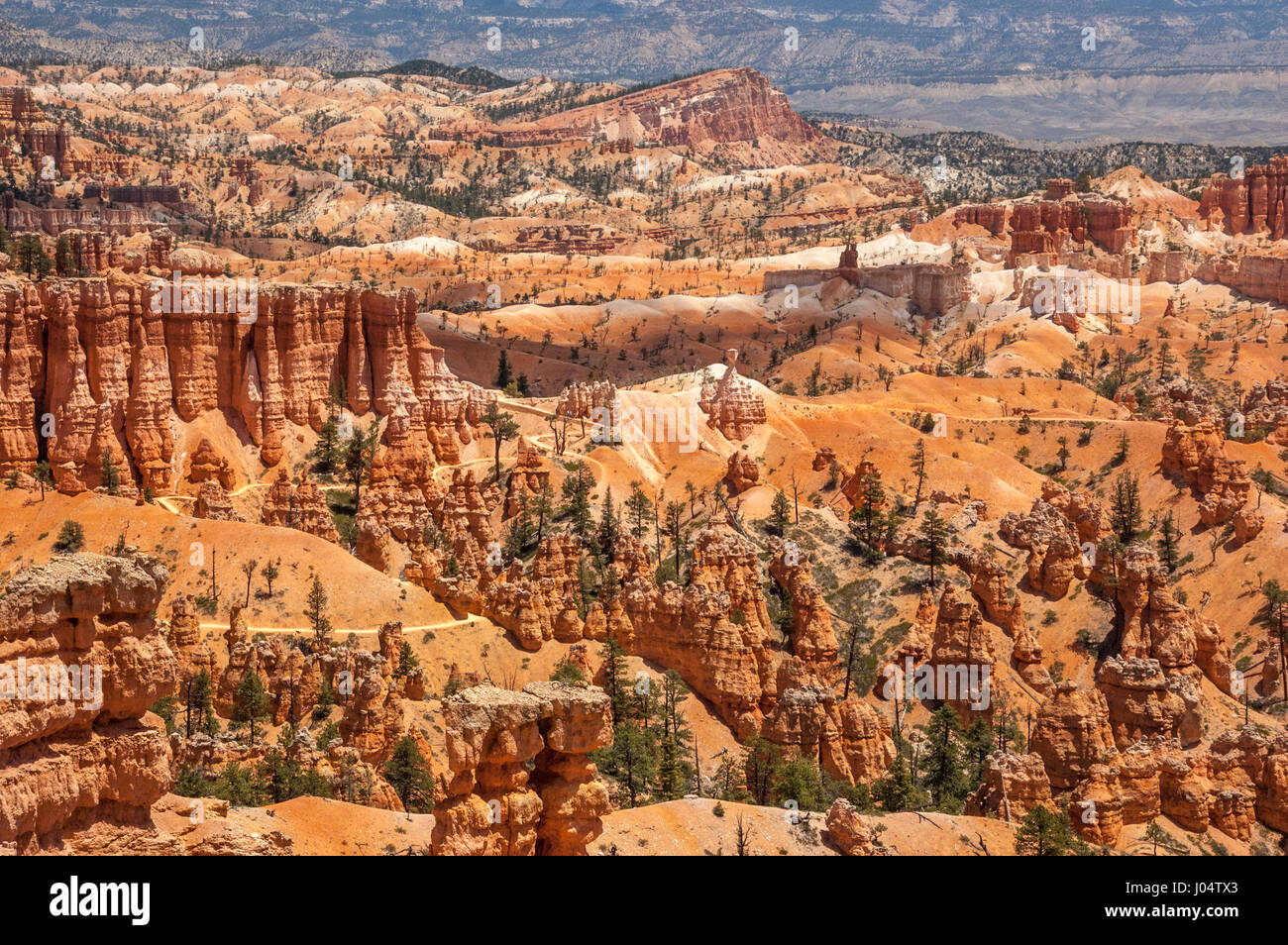 Full moon appears next to a vertical rock face colored rust by a ...