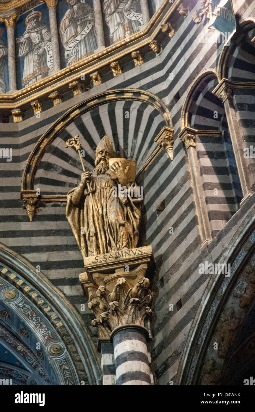 Gold statue of priest in Gothic Italian church Stock Photo - Alamy