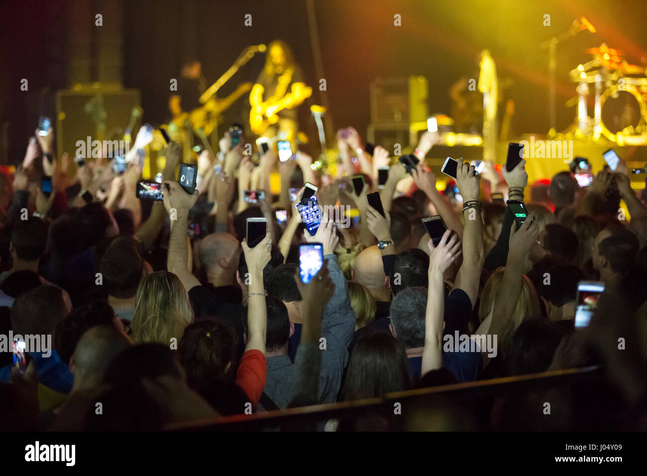 Crowd at concert and blurred stage lights . Close up of photographing ...