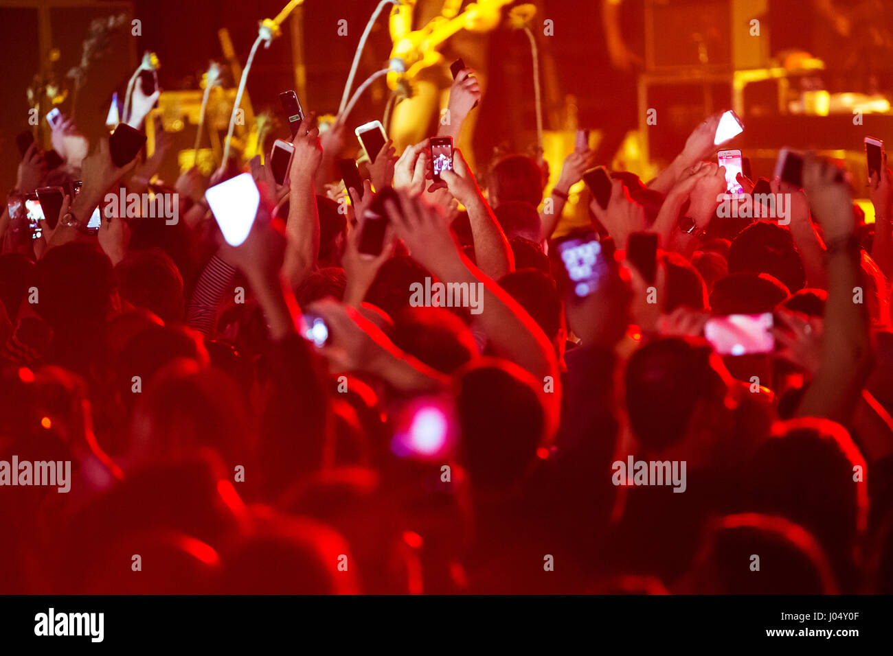 Crowd at concert and blurred stage lights . Close up of photographing ...