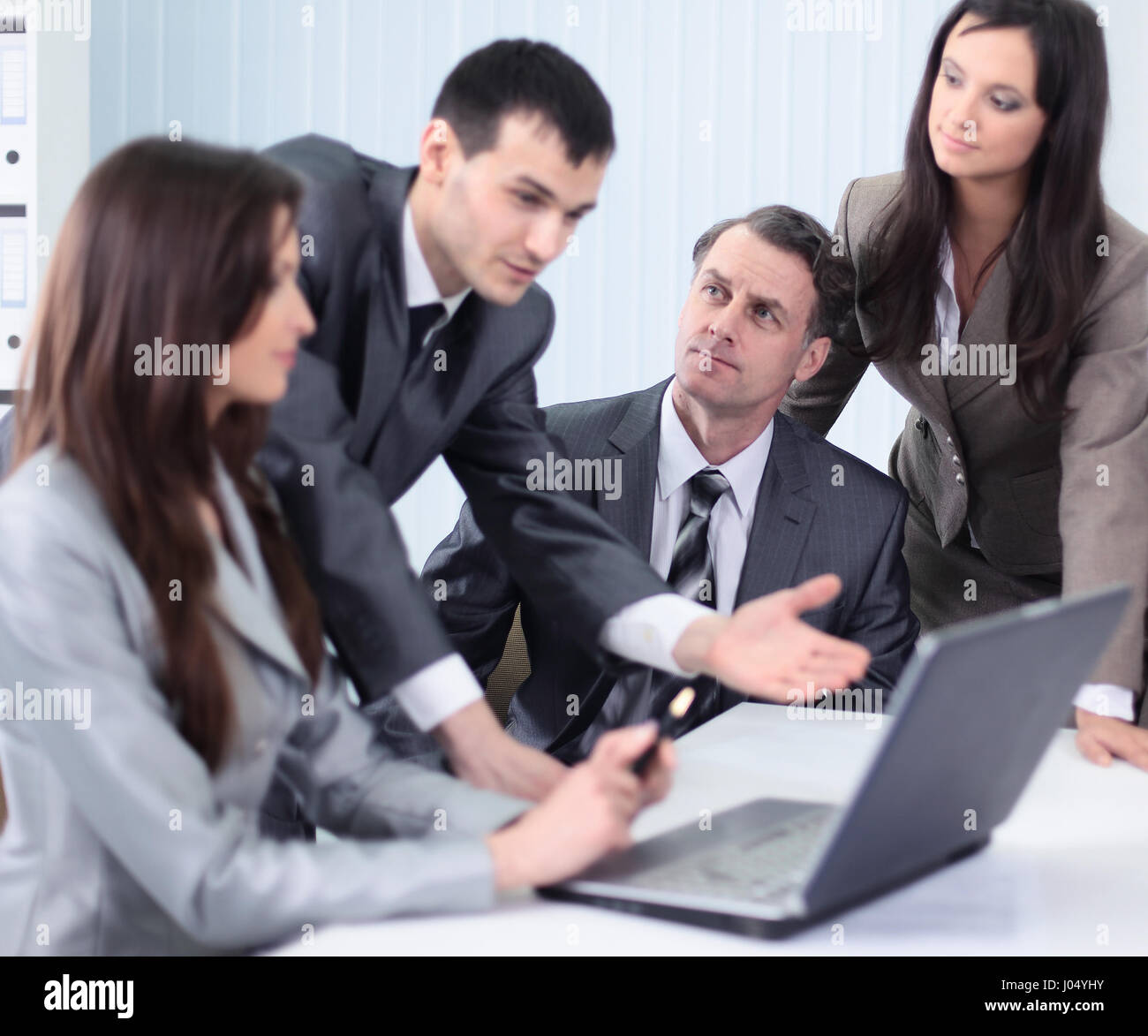 Serious colleagues discussing something in modern office Stock Photo ...