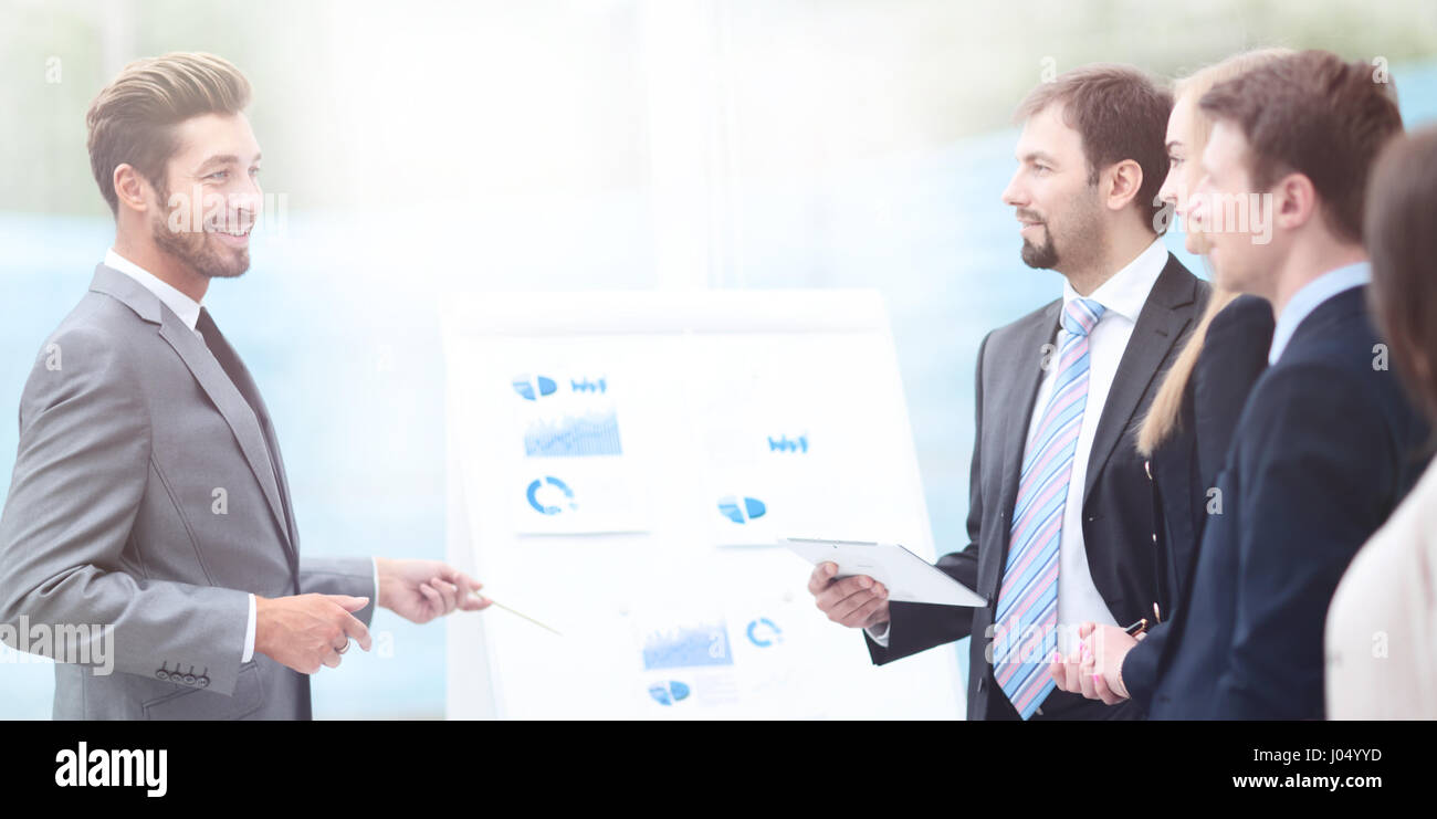 Handsome man making a business presentation to a group Stock Photo - Alamy