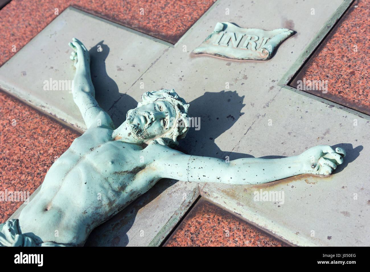 The copper statue of Jesus Christ on a tombstone Stock Photo - Alamy