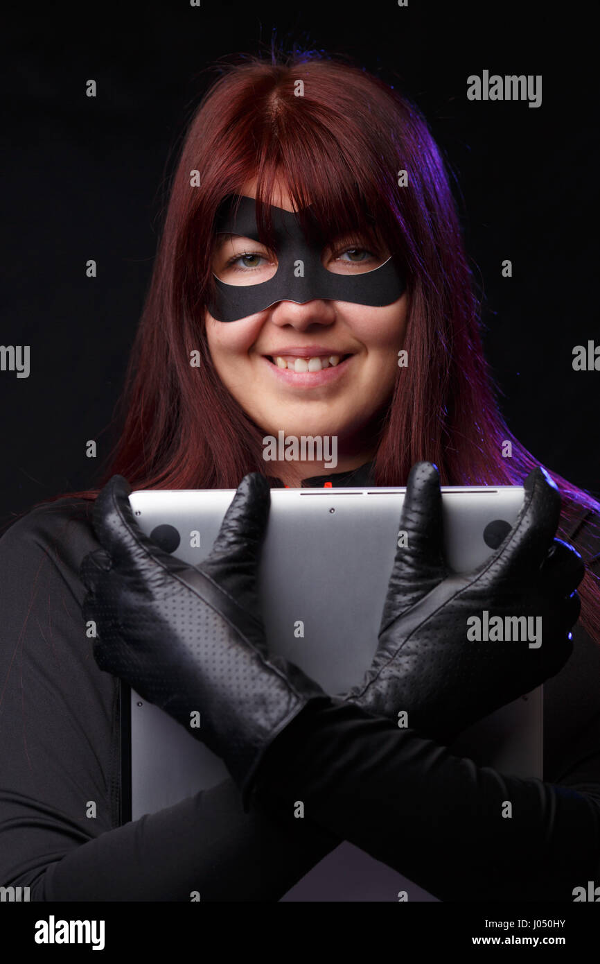 Beautiful hacker in black gloves Stock Photo - Alamy