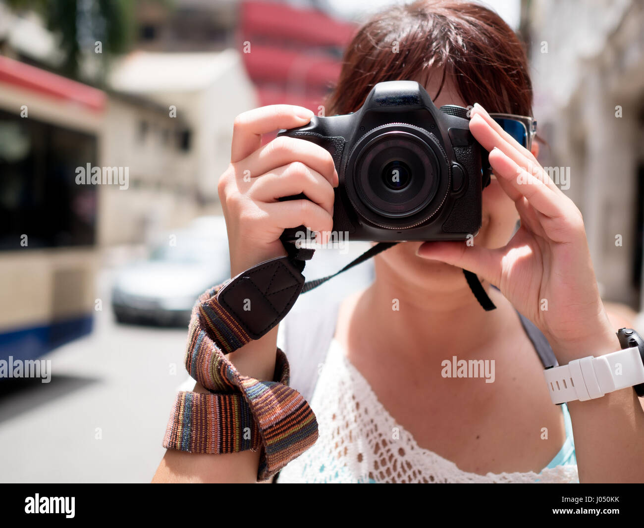Girl with camera near face Stock Photo - Alamy