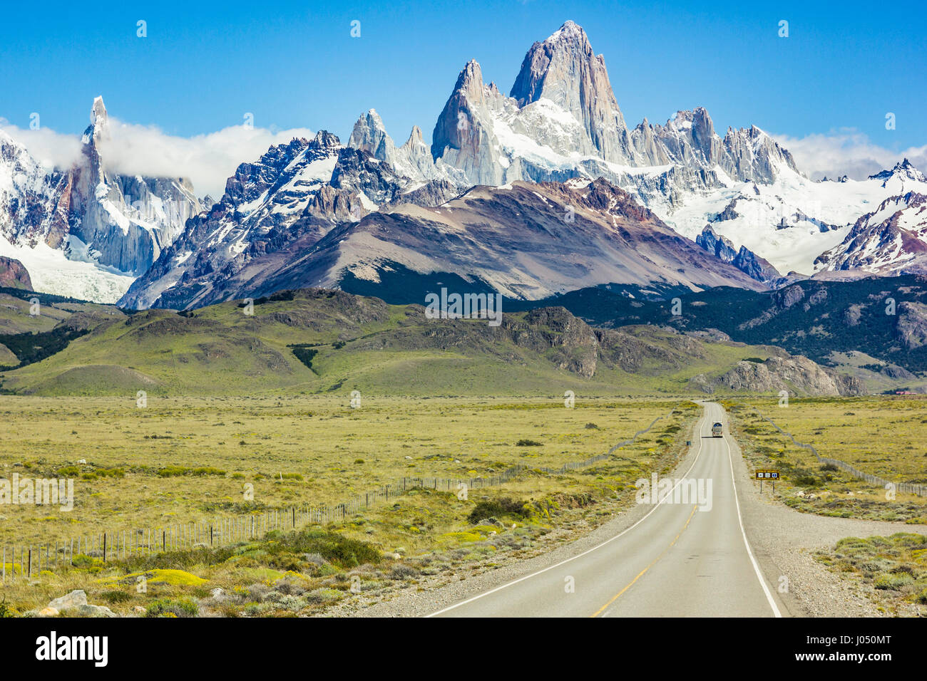 big bus going on asphalt road to mountain Fitz Roy in Argentina ...