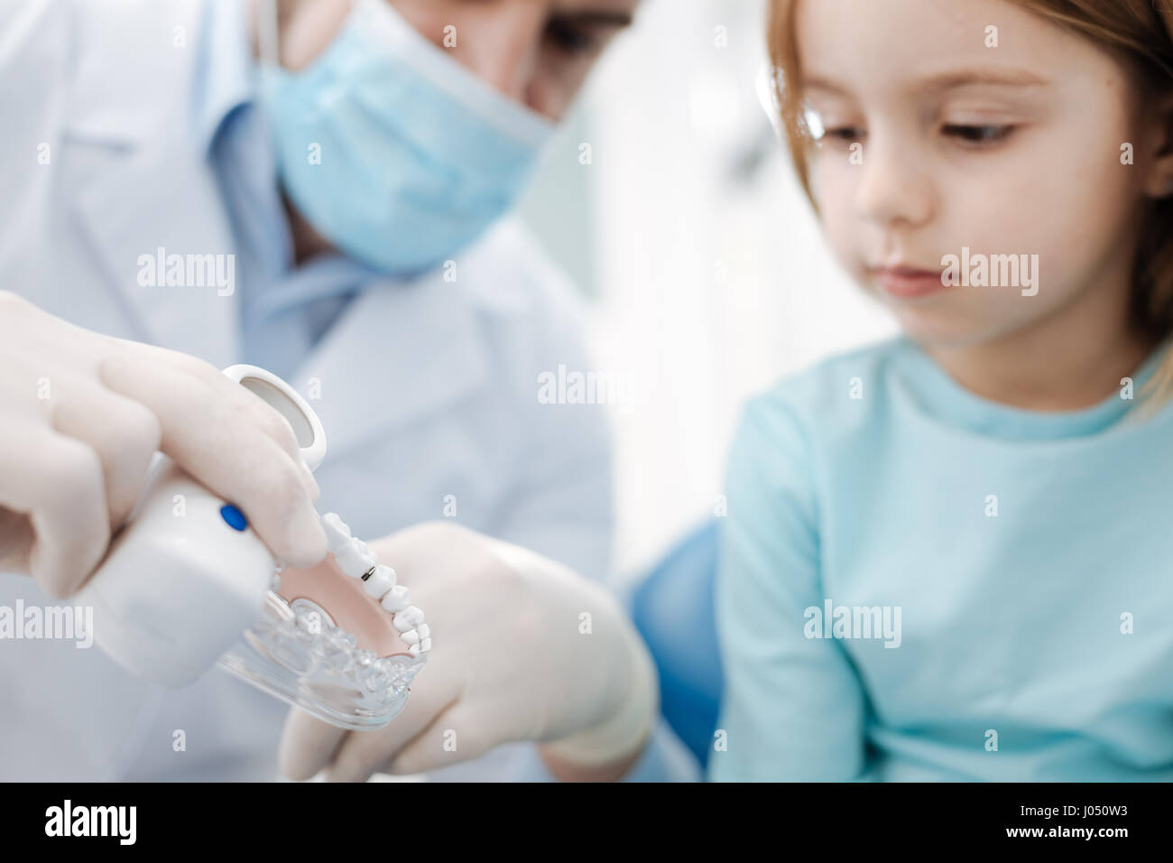 Experienced gentle doctor teaching his little patient Stock Photo - Alamy