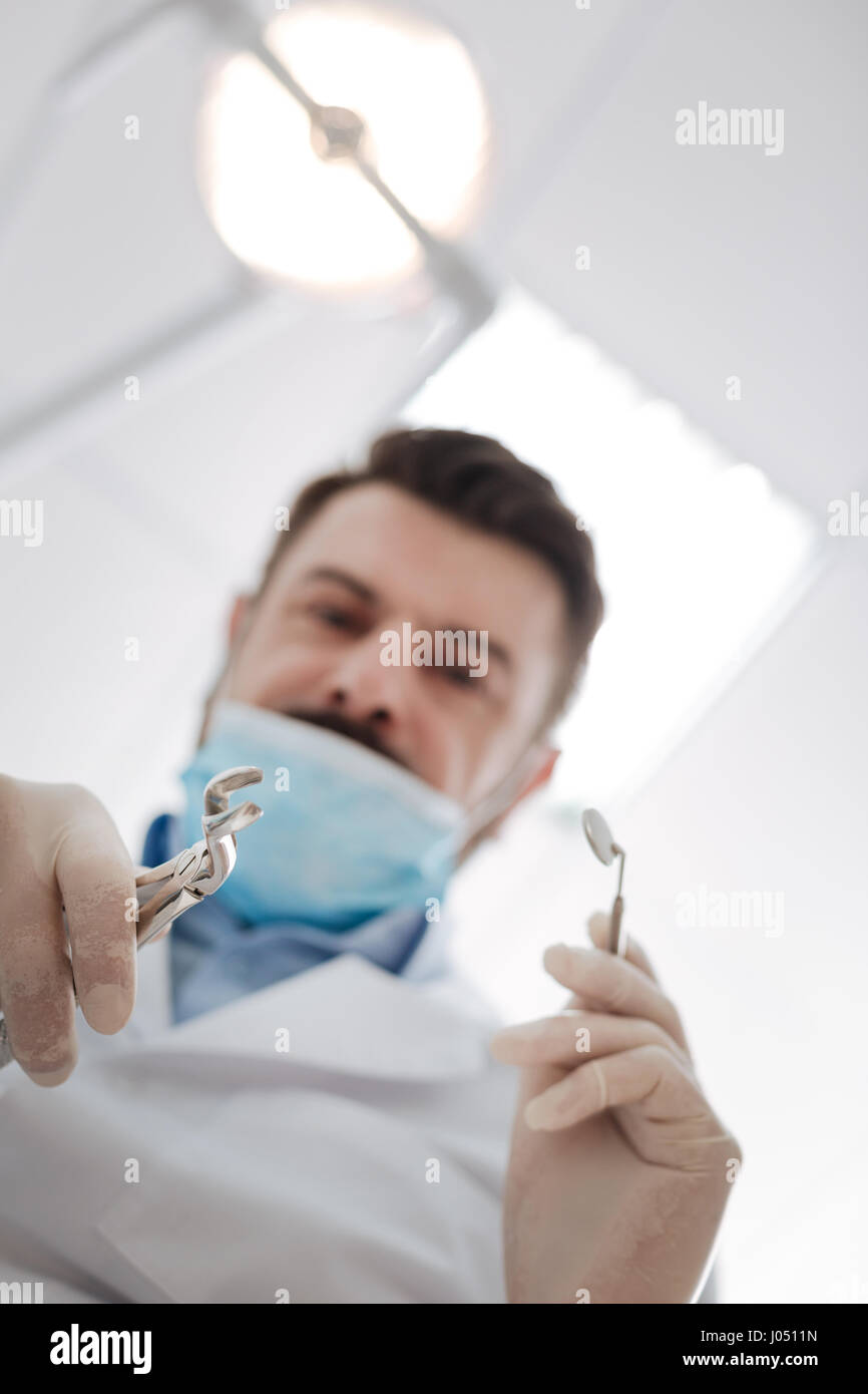 Careful professional dentist removing a tooth Stock Photo - Alamy