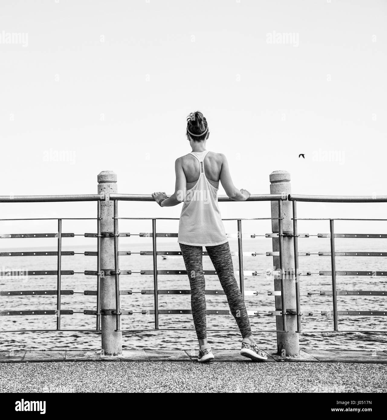 Look Good, Feel great! Seen from behind young woman in fitness outfit ...