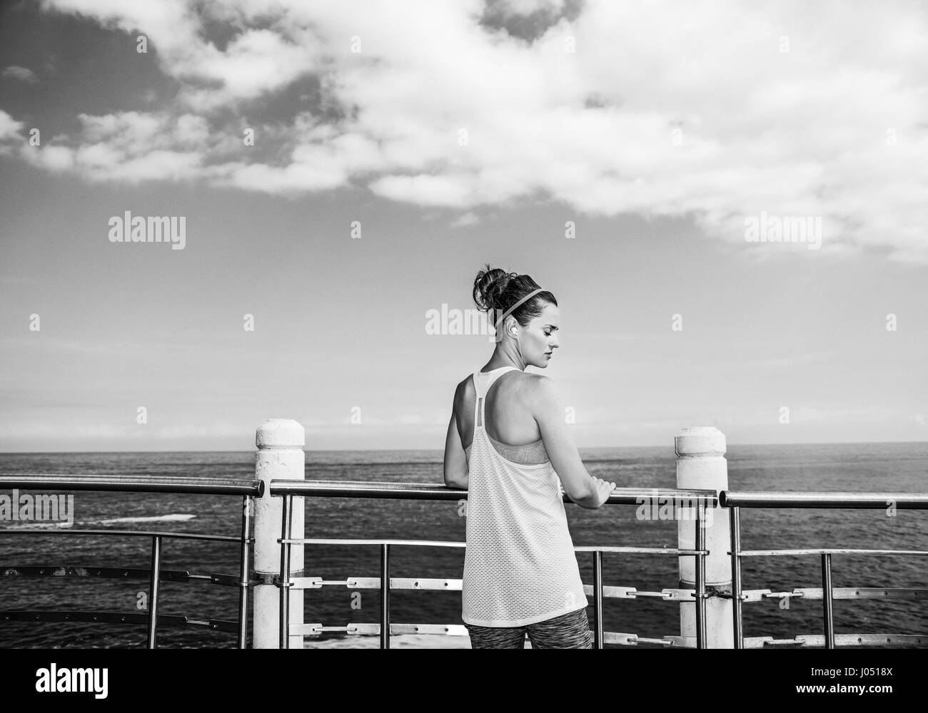Look Good, Feel great! Seen from behind young athlete in fitness outfit ...