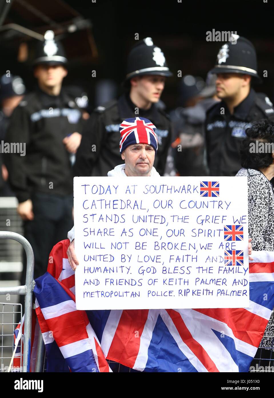 John Loughrey holds a sign outside Southwark Cathedral in London ...