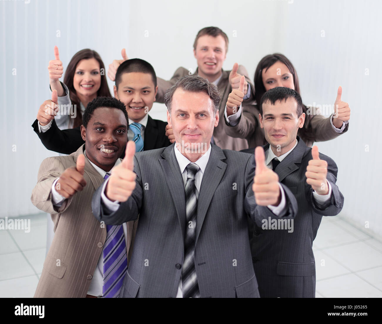 Happy colleagues showing thumbs up in their office Stock Photo - Alamy