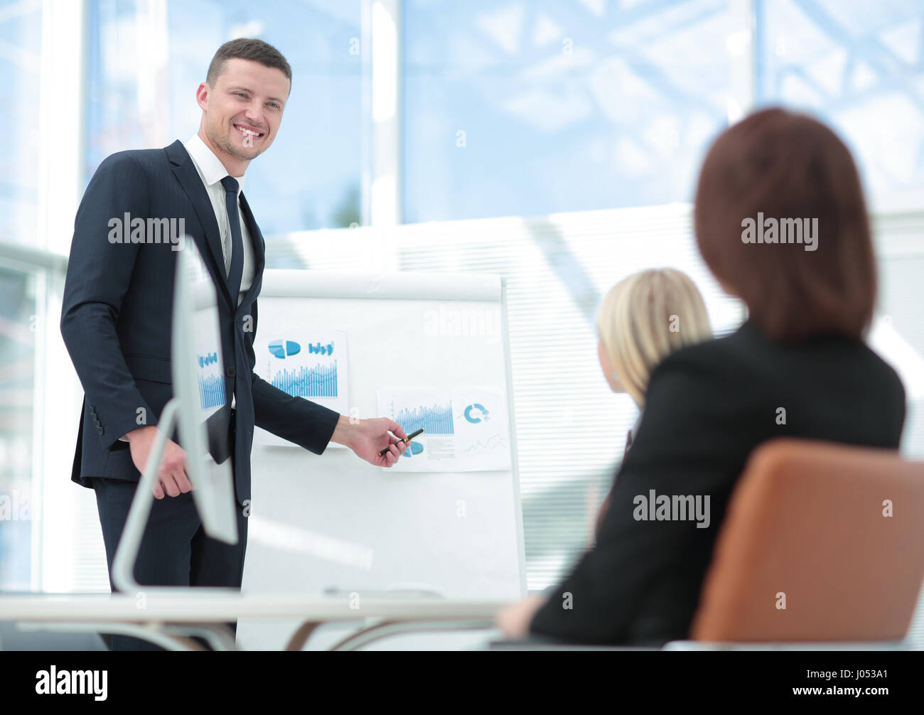 Attractive man making a business presentation to a group Stock Photo ...