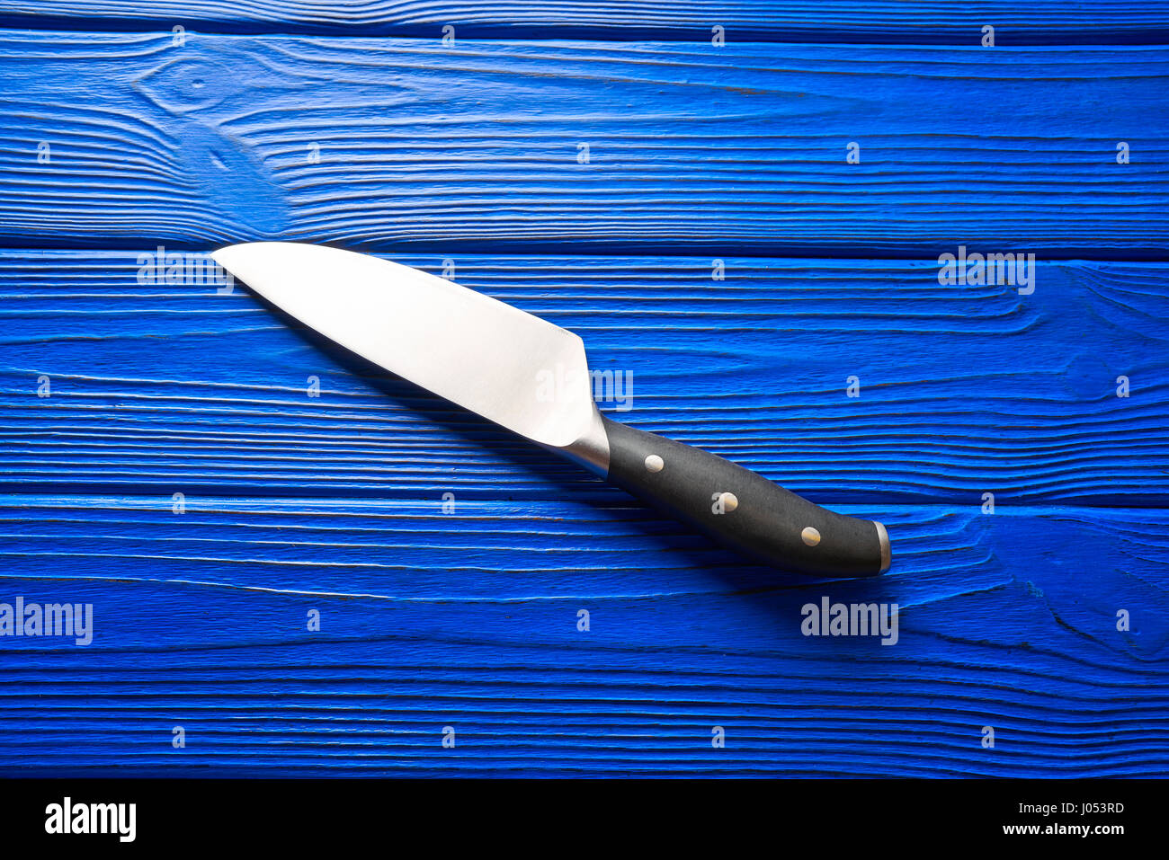 Chef tools black knife on a blue wooden background Stock Photo - Alamy