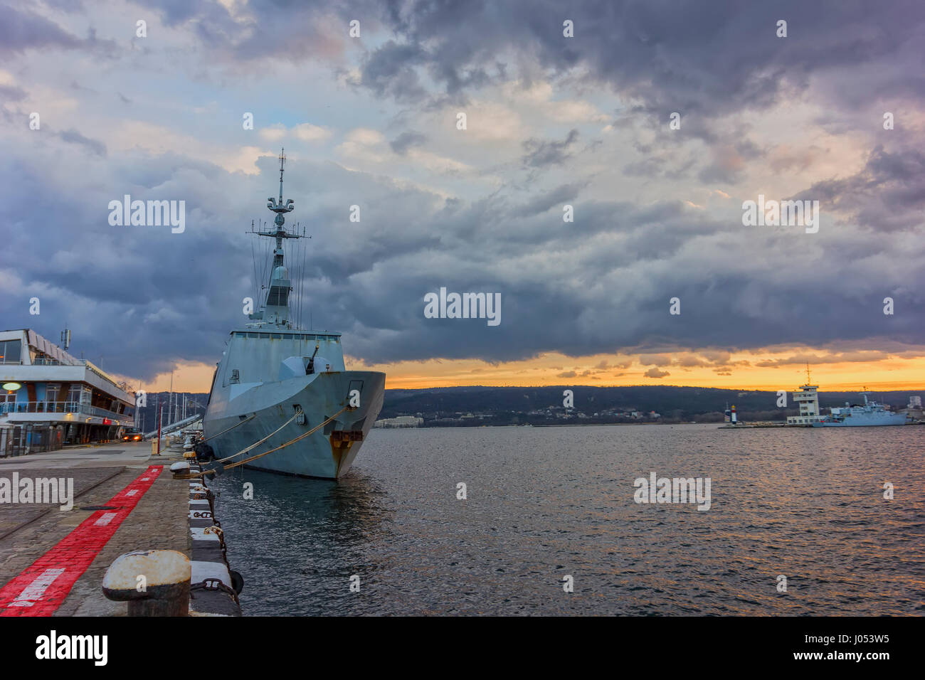 Military navy ship in port. Military sea landscape with cloudy sky at ...