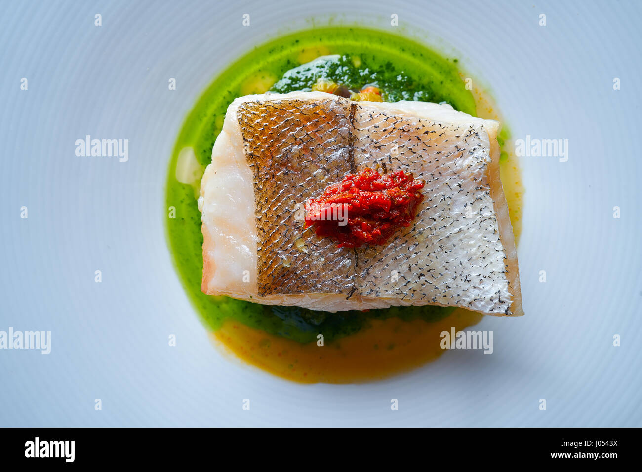 Atlantic hake over dried tomato ratatouille recipe Stock Photo - Alamy