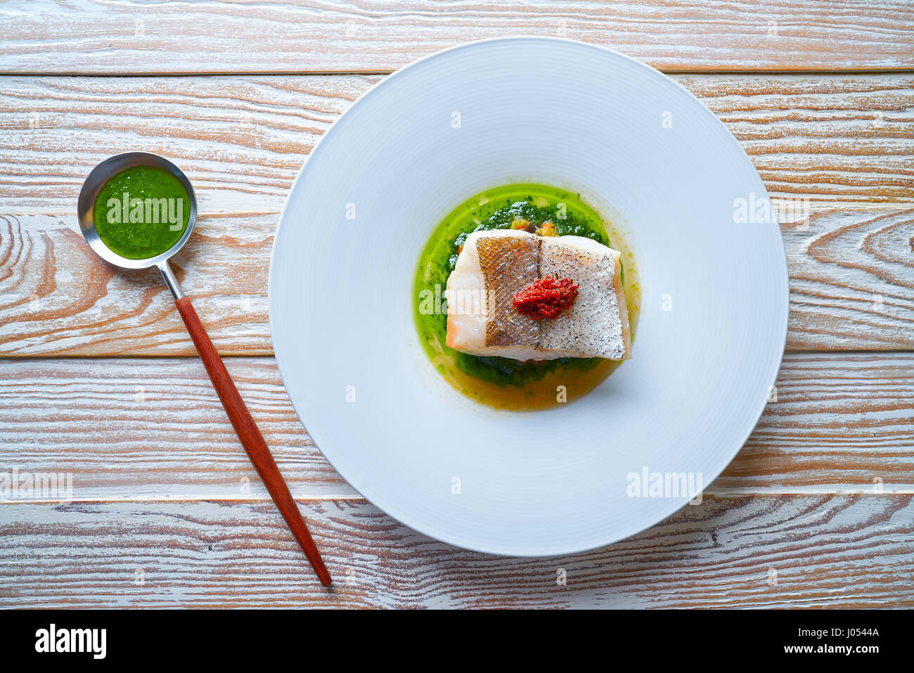 Atlantic hake over dried tomato ratatouille recipe Stock Photo - Alamy