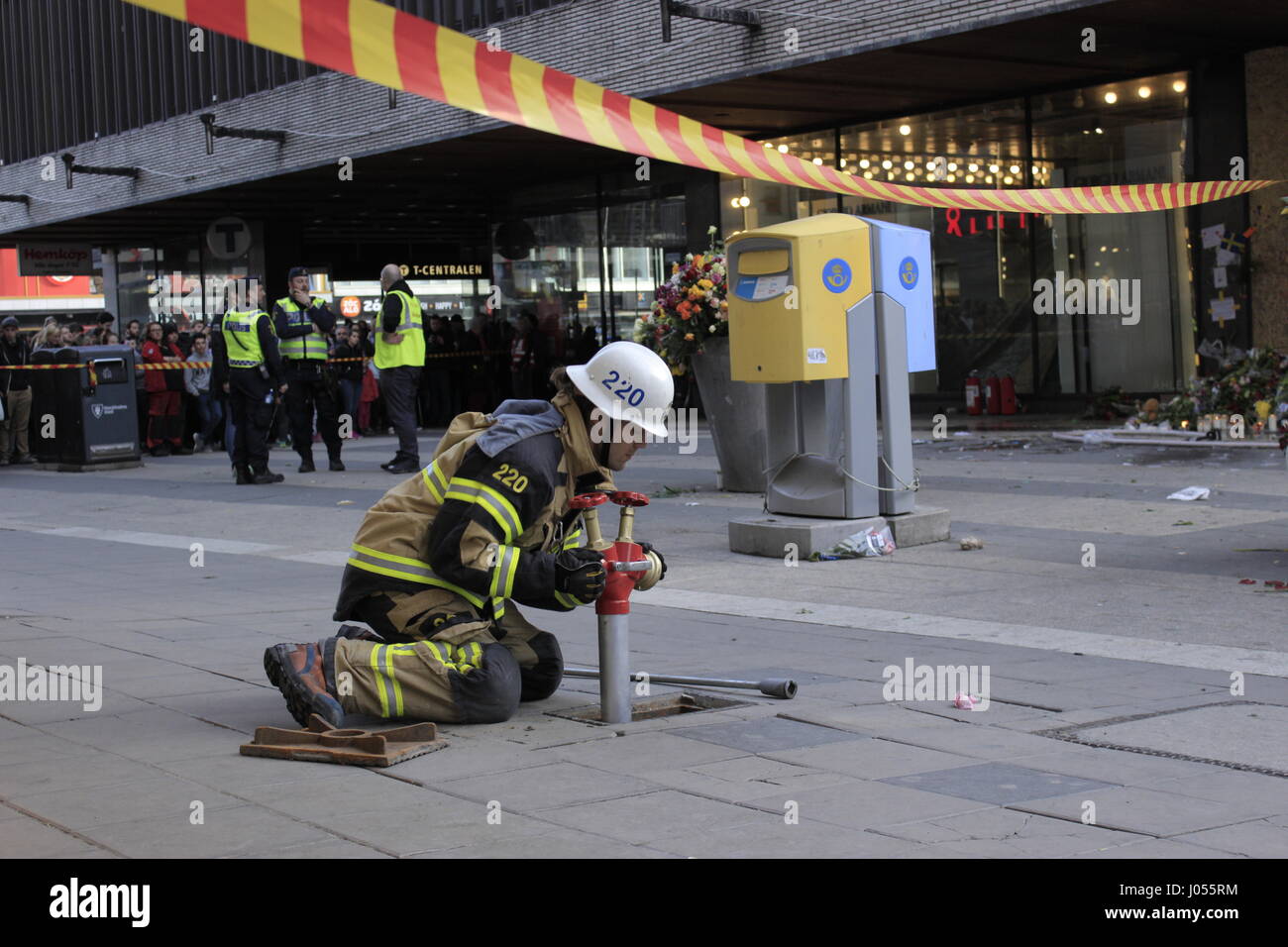 Stockholm Fire brigade fireman, installs a water pump in Drottninggatan ...