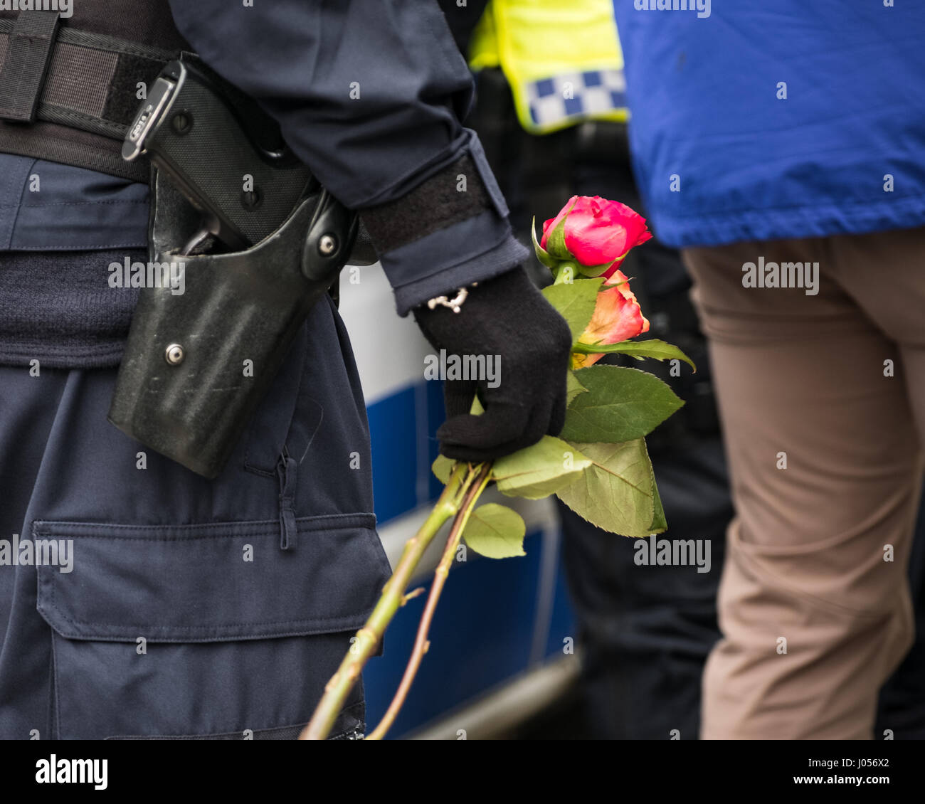 Stockholm, Sweden. 10th Apr, 2017. Police woman with gun and roses ...