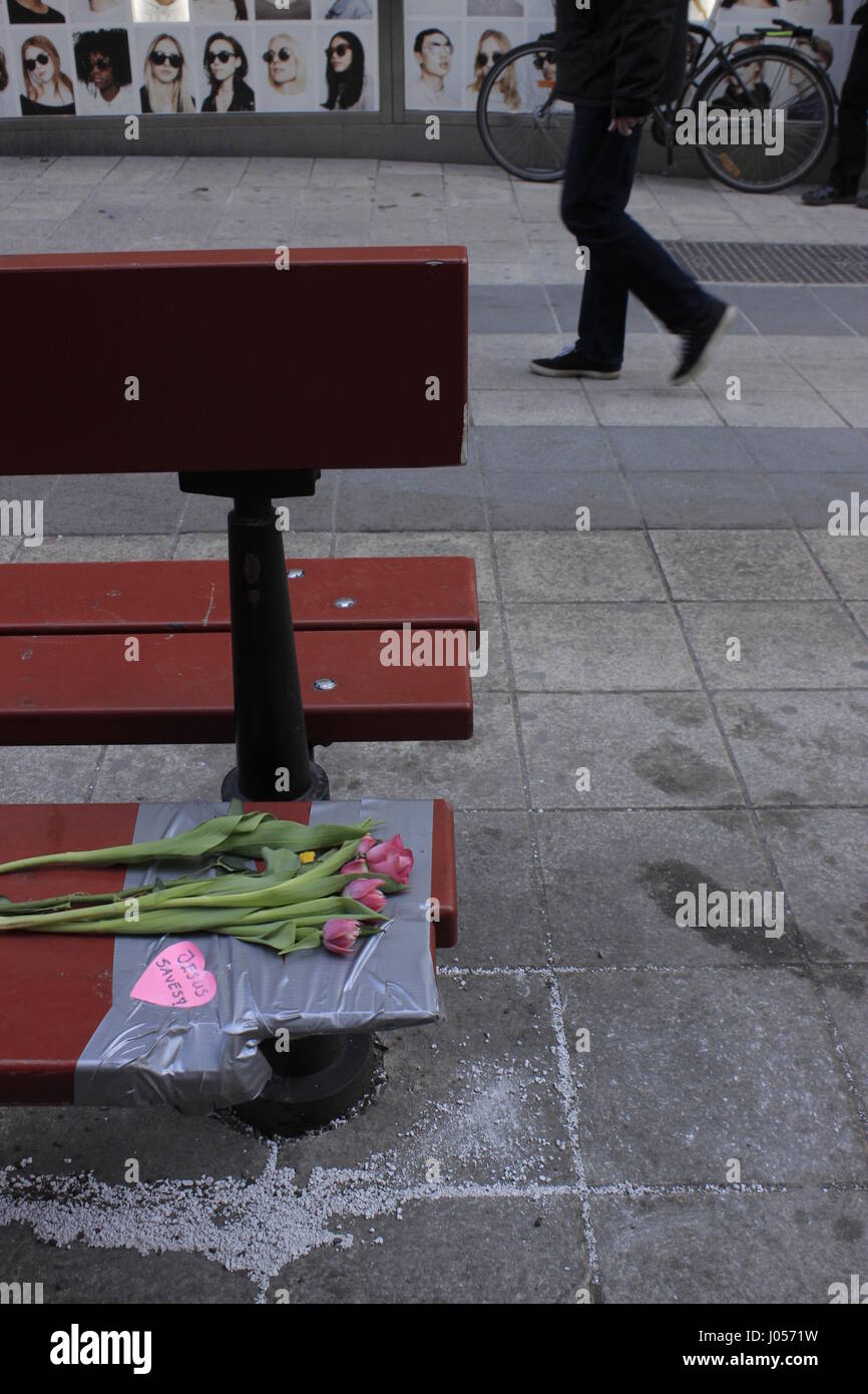 Deadly street bench hit spot marked with gaffers tape and some flowers ...