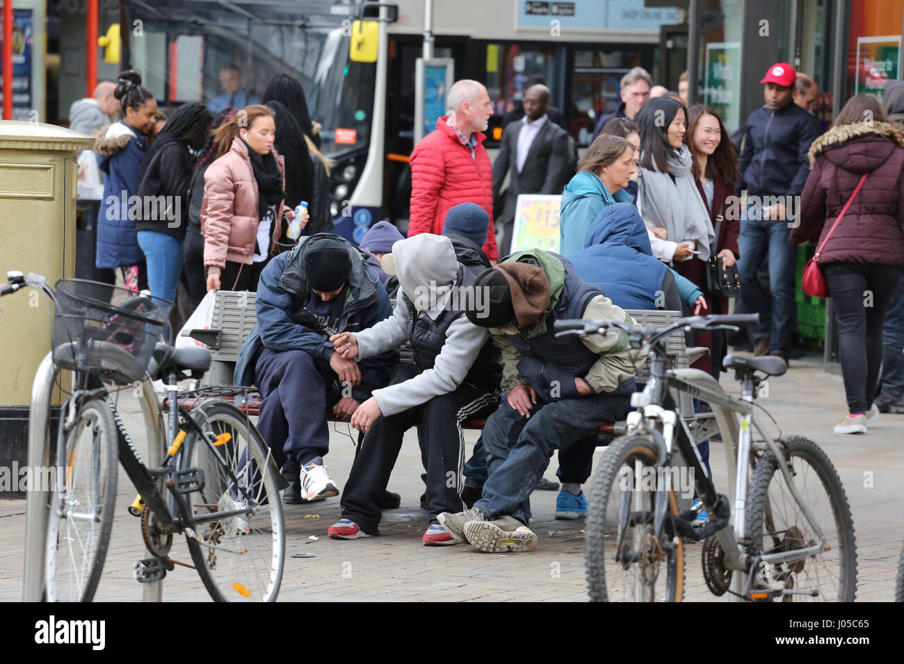 Manchester, UK. 10th Apr, 2017. Homeless people sat on a bench, one of ...